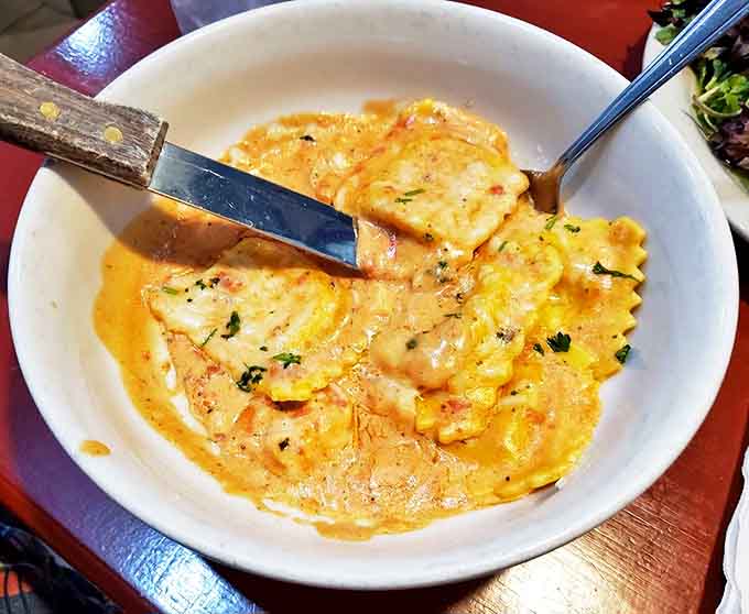 Lobster ravioli that makes you want to applaud &ndash; plump pasta pillows swimming in a rich, coral-hued sauce that tastes like the ocean bottled its finest flavors.