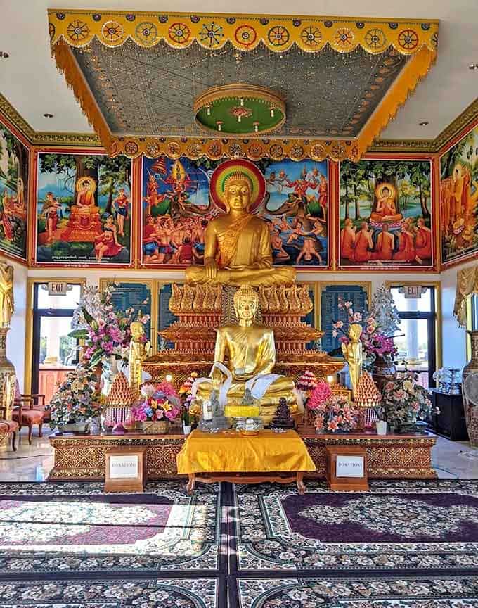 Inside the main shrine, time seems to slow as golden Buddhas sit in eternal meditation, their serene expressions a universal language of peace.