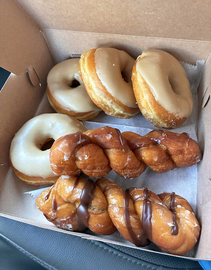 The maple-glazed and twisted beauties sit side by side like old friends, each waiting to be the highlight of someone's morning coffee break.