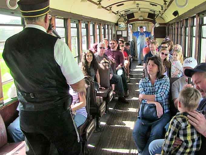 All aboard! Passengers settle in for their journey through time as the conductor prepares to share railroad lore and local history.