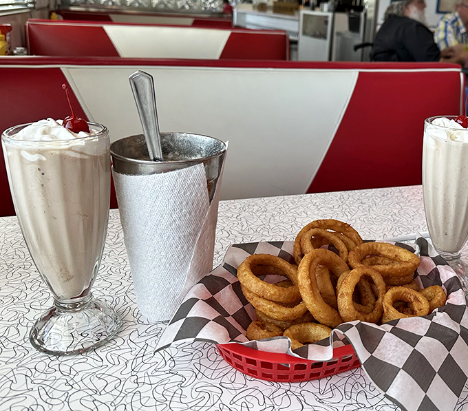 The ultimate power couple &ndash; a creamy milkshake and crispy onion rings proving that opposites don't just attract, they create culinary magic together.