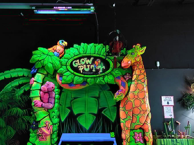 Tropical creatures and lush foliage frame the mini-golf entrance, creating a portal to a phosphorescent paradise that would make Avatar look understated.