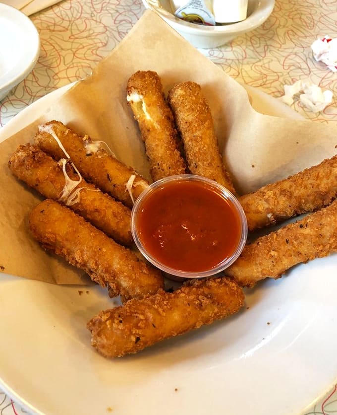 Golden-brown mozzarella sticks with that perfect cheese pull &ndash; the kind that makes you wonder why anyone would mess with such a perfect formula.