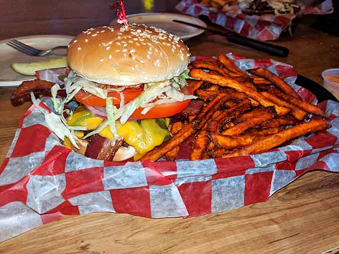 Burger perfection achieved: juicy patty, melty cheese, fresh toppings, and sweet potato fries that'll make you question your loyalty to regular potatoes.