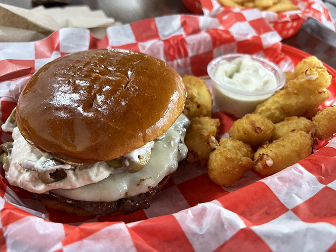 The Olive Smash burger alongside golden cheese curds – a combination that makes you wonder why you'd ever eat anything else.