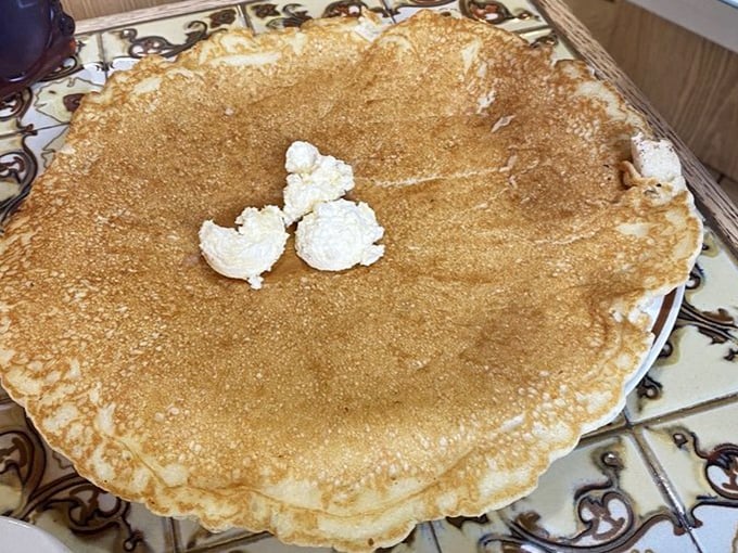 A golden disc of fluffy perfection that extends beyond its plate boundaries&mdash;the manifest destiny of breakfast foods with a melting butter crown.