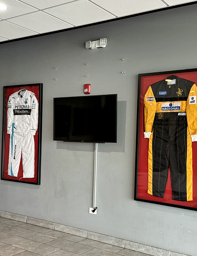 Racing memorabilia adorns the walls, including authentic racing suits that remind visitors they're participating in a sport with rich heritage and tradition.