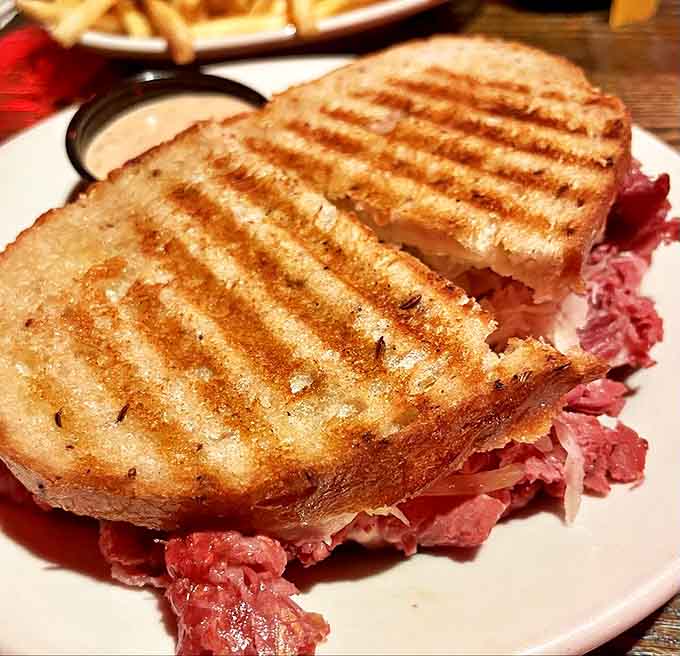 The Reuben sandwich doesn't mess around &ndash; towering layers of corned beef, sauerkraut, and melted Swiss that require both hands and dedication.