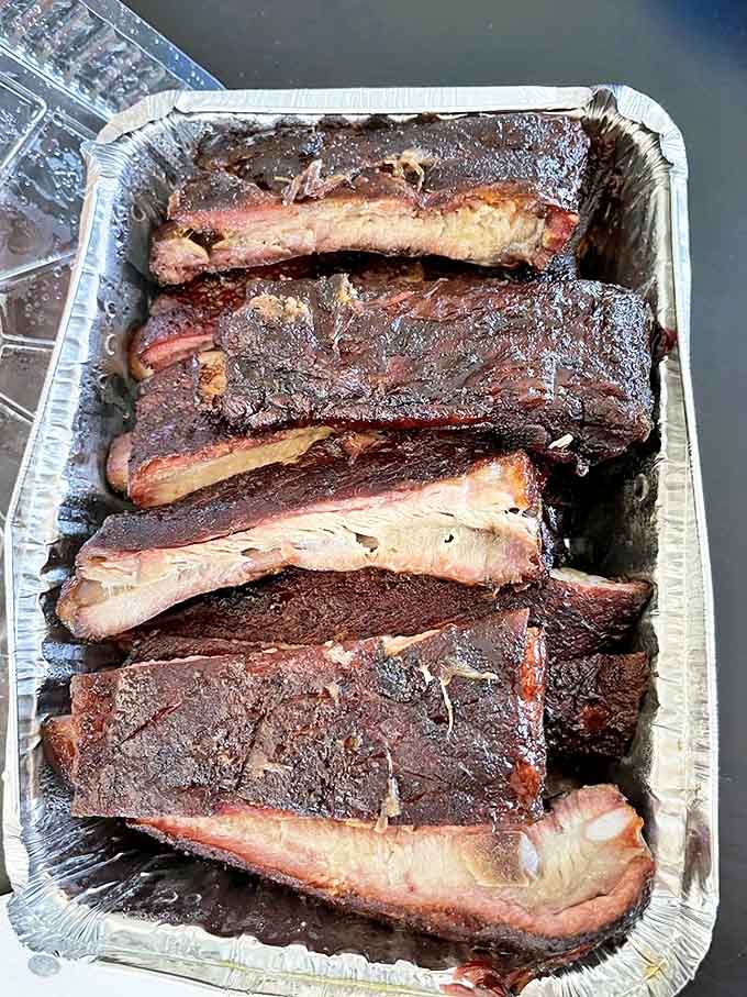 A full slab of ribs with the perfect bite &ndash; not falling off the bone, but cleanly separating with just the right resistance.