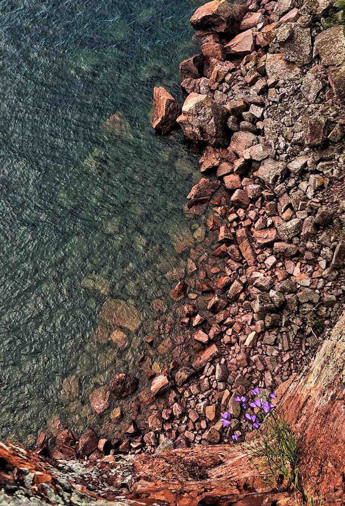 The meeting point of earth and water &ndash; Lake Superior's crystal clear waters reveal colorful stones beneath, like nature's own jewelry display.