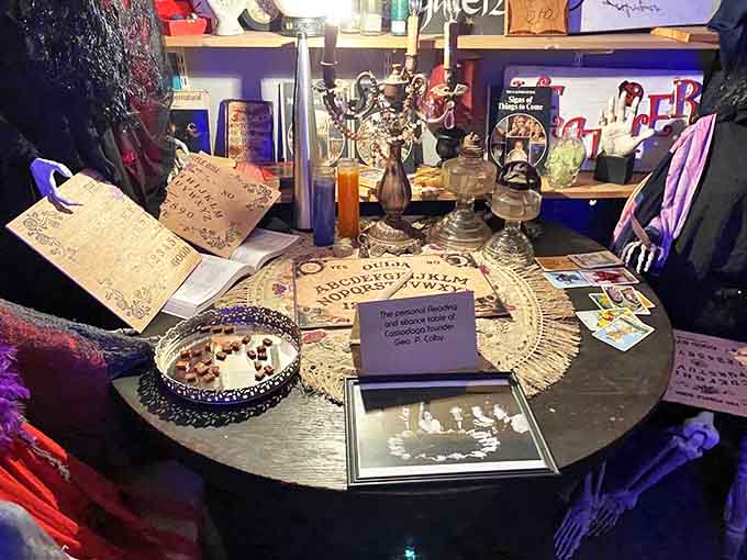 The seance table stands ready for communication with the beyond, complete with Ouija board, candles, and centuries of spiritualist tradition.