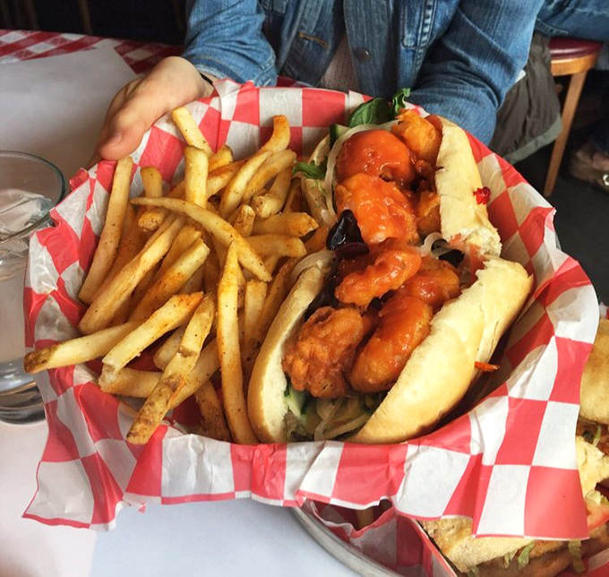 The shrimp po' boy arrives like a New Orleans postcard, crispy fried shrimp bursting from the bun with remoulade adding that perfect tang.