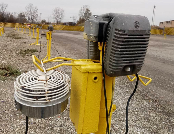 These yellow speaker posts are mostly decorative now, relics from when sound came through attached speakers instead of FM radio.