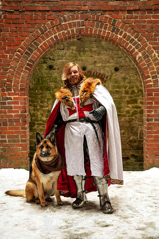 Your medieval spirit comes to life here as you pose in noble attire with your loyal, furry companion by your side.