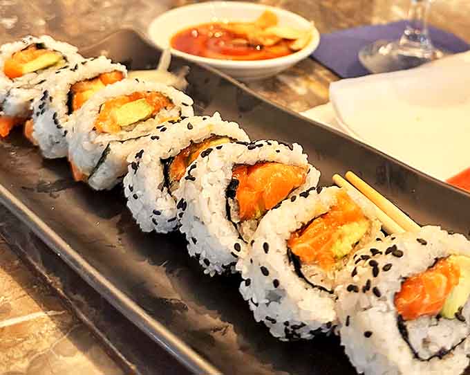 Even the sushi rolls seem to arrange themselves with the same precision as a well-crafted jazz arrangement.