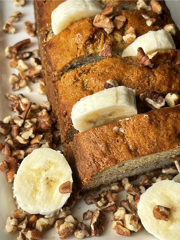 Banana bread sliced thick and studded with walnuts makes breakfast feel like a special occasion every single day.