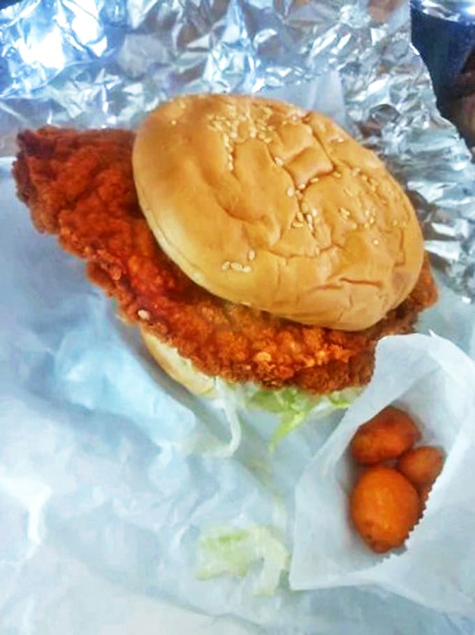 The tenderloin sandwich that proves size matters when it comes to comfort food, stretching beyond its bun with admirable confidence and zero apologies.