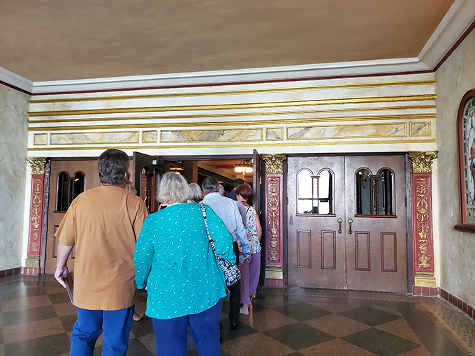 Theatergoers file through ornate doorways, embarking on a journey that's as much about the venue as the performance they've come to see.
