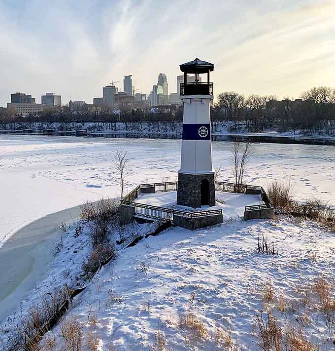 Winter transforms Boom Island into a magical snow globe scene, with the lighthouse standing defiant against Minnesota's famous chill.