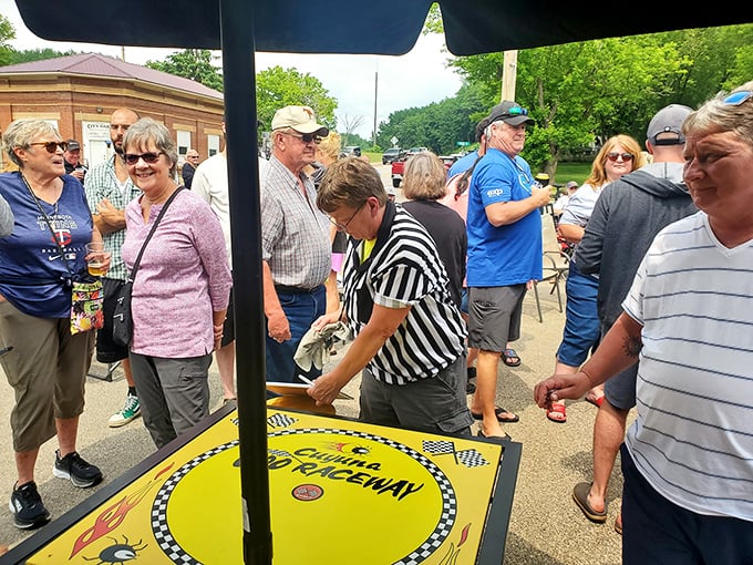 This fun outdoor gathering features a lively tabletop game and friendly faces. That checkered referee shirt is waiting for the next round!