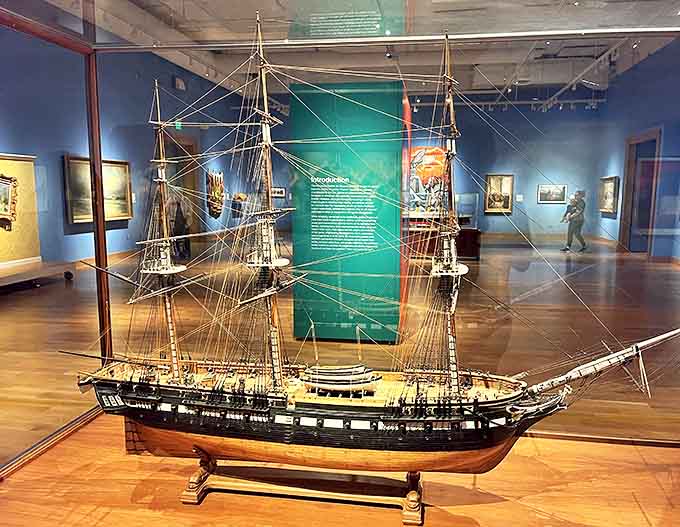 A ship: This meticulously crafted model vessel sits proudly behind glass, its tiny rigging and perfect proportions telling tales of maritime adventure without saying a word.