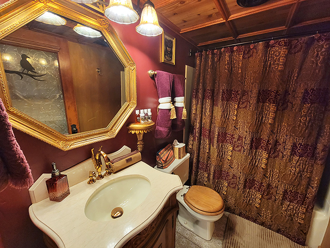 Captain Nemo would feel right at home in this bathroom, where copper fixtures and rich burgundy transform morning routines into underwater adventures.