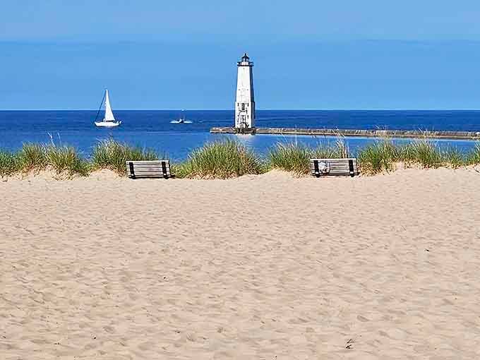Beach View: Two wooden benches offer front-row seats to Lake Michigan's endless horizon show, with the lighthouse playing a supporting role.