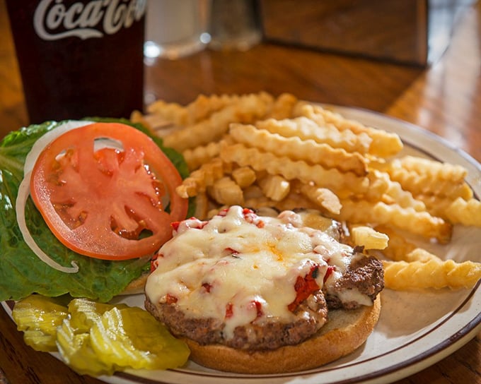 Crispy crinkle-cut fries and a juicy burger topped with fresh vegetables &ndash; proof that happiness can indeed fit on a plate.
