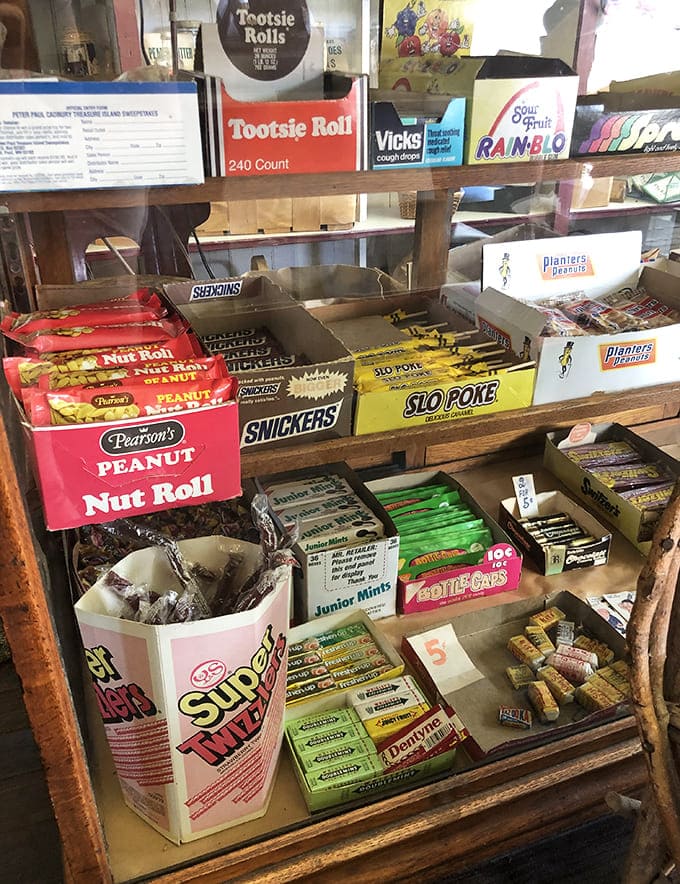 Sweet nostalgia fills these wooden compartments – Nut Rolls, Snickers, and candies that taste like childhood memories waiting to be unwrapped.