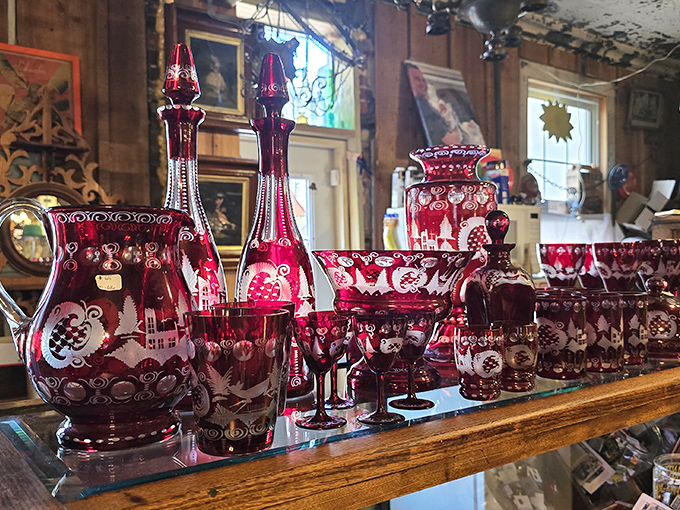 Ruby red Bohemian glassware catches light like liquid garnets – each cut crystal piece telling stories of European dinner parties from another century.