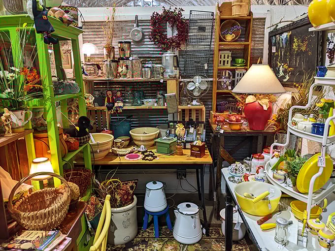 A vibrant and eclectic collection of rustic and antique housewares, featuring everything from enamelware pots to colorful mixing bowls and seasonal decorations.