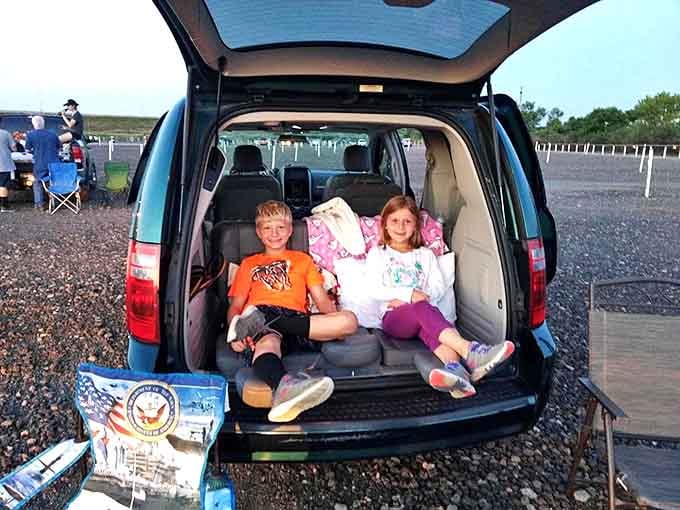 The ultimate kid-approved movie experience – turning the family SUV into a cozy nest of blankets and pillows for an evening under the stars.