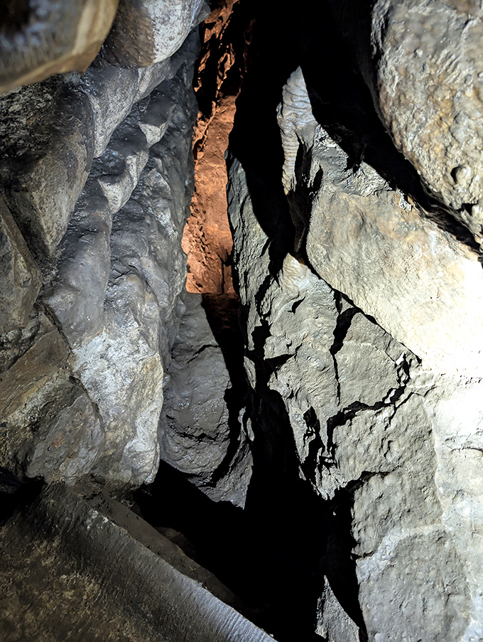 A narrow passage reveals the cave's intricate network of corridors, where adventurous souls can explore nature's underground architecture.
