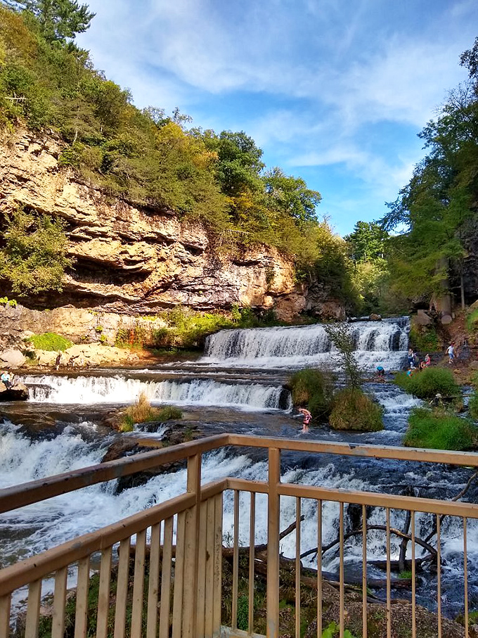 Summer brings perfect wading conditions, with sunlight illuminating the stepped limestone formations that create this natural wonder.