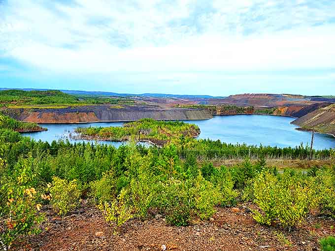 Nature's color palette on full display – emerald forests meet azure waters against the dramatic backdrop of iron-rich cliffs.