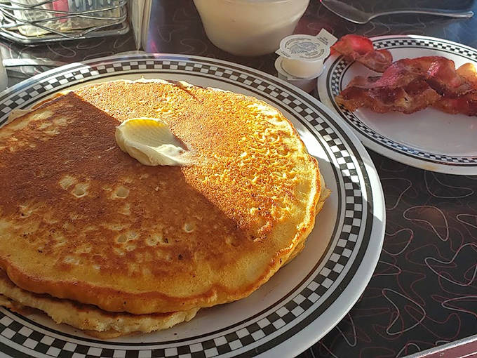 Pancakes that hang over the edge of the plate, golden-brown and ready to soak up rivers of maple syrup.