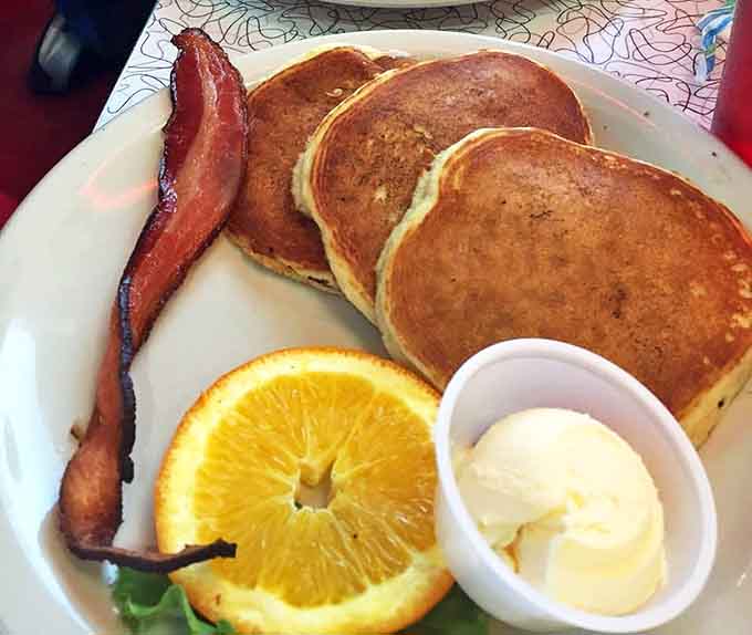 Pancakes that could double as pillows arrive with crispy bacon and a pat of butter slowly melting into breakfast perfection.