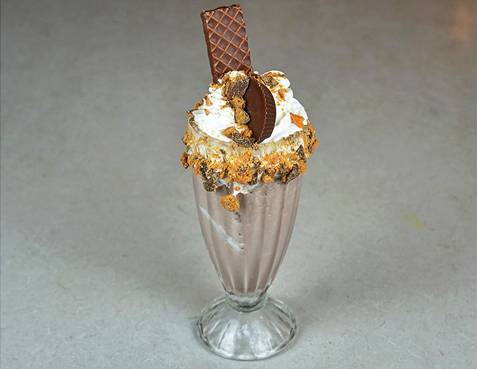This isn't just a peanut butter milkshake&mdash;it's a monument to excess with chocolate wafers and crumbles creating a crown fit for dessert royalty.