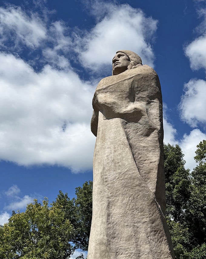 The side view showcases the statue's impressive profile, with flowing lines that somehow make 536,770 pounds of concrete look almost graceful.