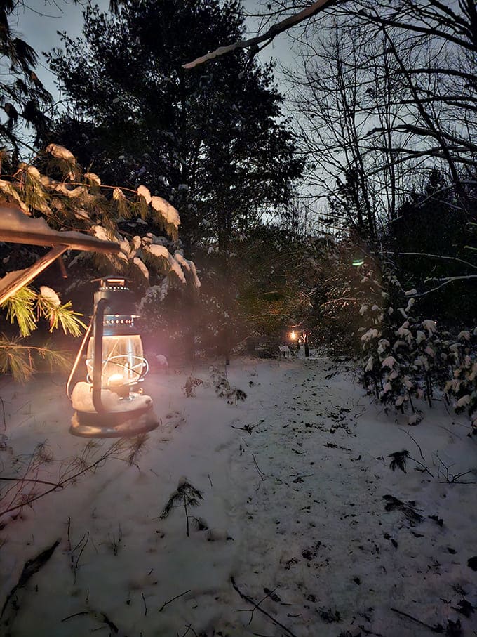 Those vintage lanterns glowing in the snow create ambiance that no interior designer could ever replicate indoors.