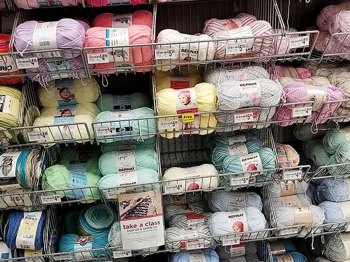 Balls of yarn nestled together like a textile rainbow, each skein whispering promises of cozy scarves and heirloom blankets.