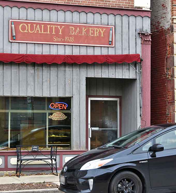 That weathered exterior and old-school awning tell you this bakery has been perfecting its craft for generations, and boy does it show