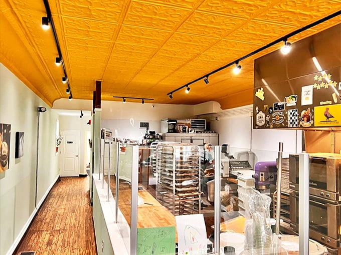 The bakery's warm interior with its golden ceiling creates the perfect backdrop for showcasing their handcrafted breads and pastries.