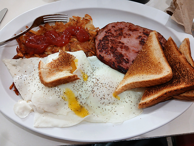 Breakfast perfection on a plate &ndash; golden-edged eggs, crispy hash browns, and toast that somehow manages to be both buttery and light.