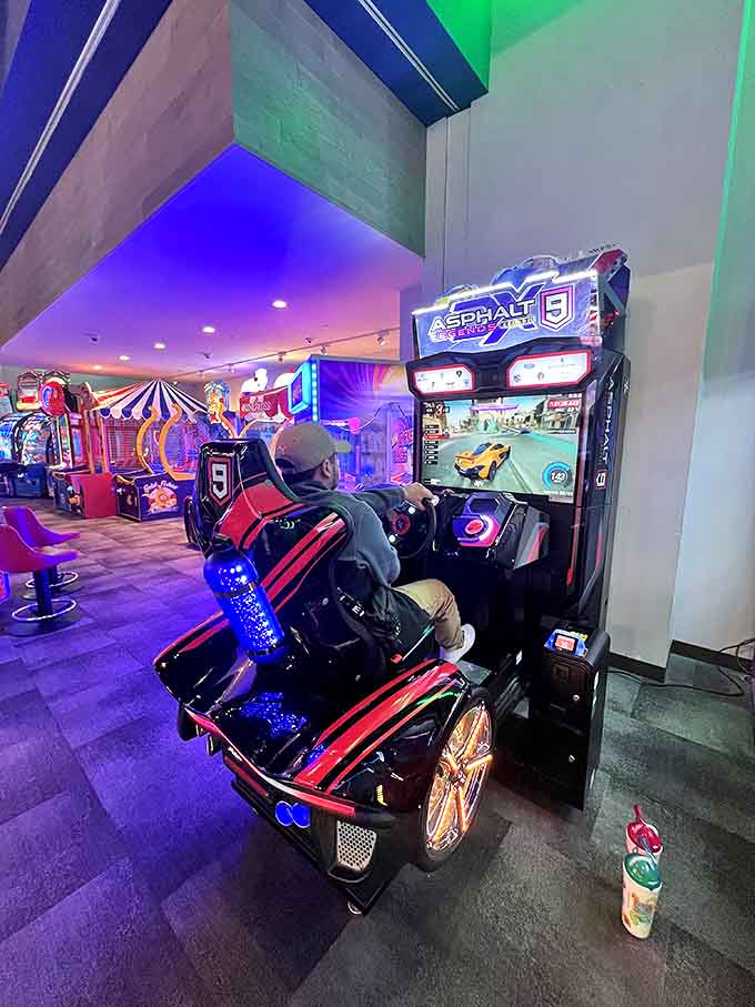 The arcade's neon glow beckons gamers of all ages to test their skills, where friendly competition and ticket-winning strategies create dry-land excitement.