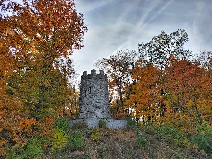 Autumn transforms the castle's surroundings into a painter's palette of oranges and reds, framing the medieval stonework perfectly.