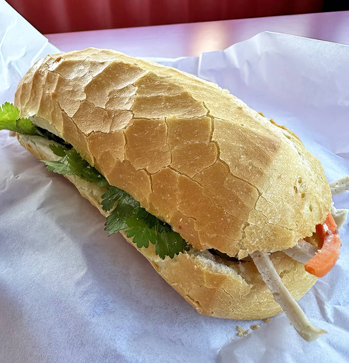 A b&aacute;nh m&igrave; masterpiece &ndash; crusty-outside, tender-inside baguette filled with savory delights and bright, crunchy vegetables.
