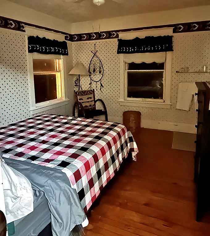 Guest rooms maintain period-appropriate charm with details like plaid bedspreads and vintage furnishings that transport you to simpler times.