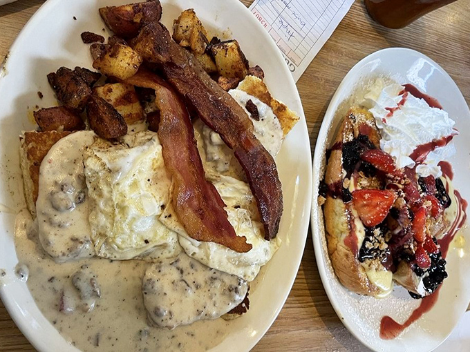 A breakfast duet that sings – savory biscuits and gravy sharing the spotlight with sweet berry-topped French toast.
