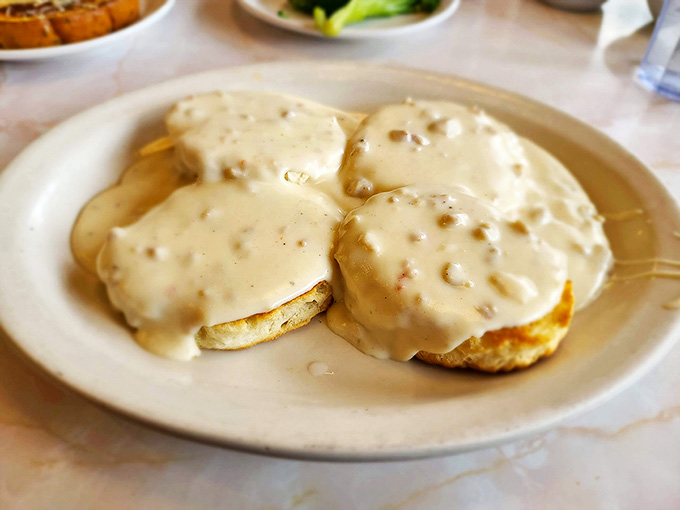 These biscuits and gravy aren't just a meal &ndash; they're a Southern hug on a plate, smothered in peppery cream gravy.